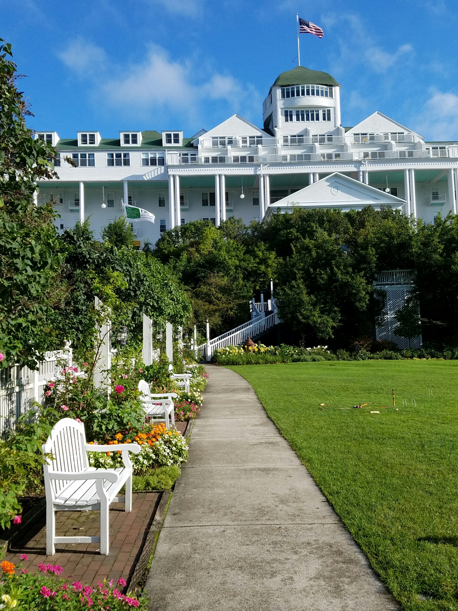 Mackinac_white-bench-sidewalk-hotel-flag-background - Perennially Yours